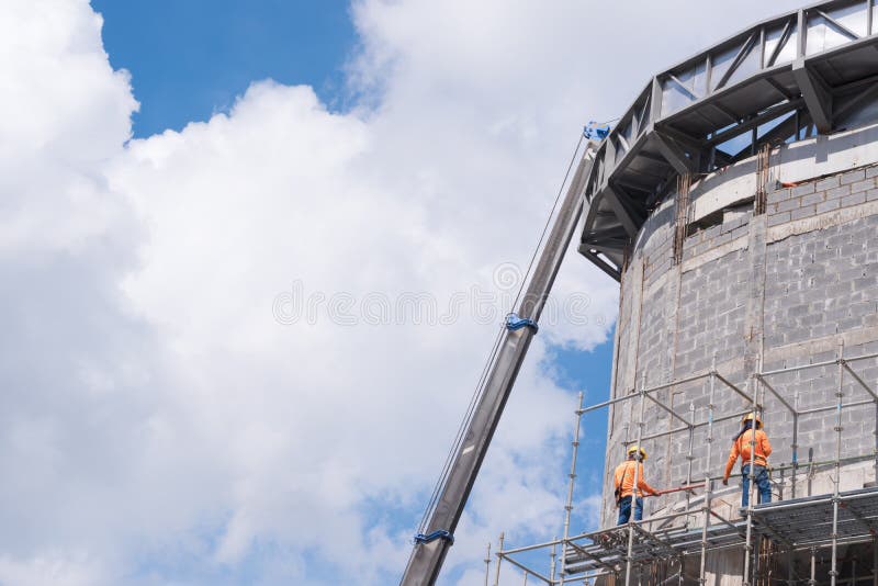 Back Side of Construction Workers are Working on Top of Building ...