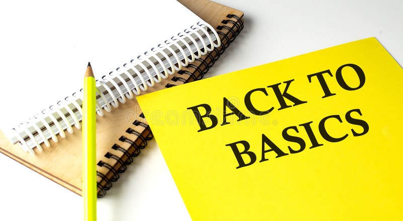 BACK TO BASICS Text Written on a Yellow Paper with Notebook Stock Image ...