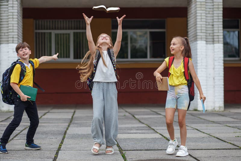 Three School Children Having Fun Outdoors. Classmates with Backpacks ...