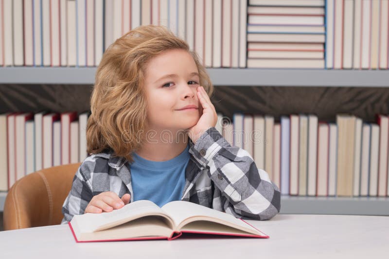 Back To School. Child Reading a Book in a School Library. School Boy ...