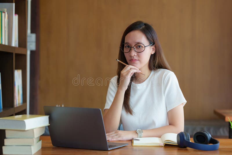 Back To School Concept. Young College Woman Using Laptop at Library ...