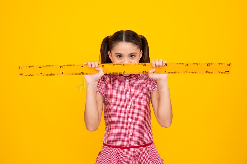 Back To School. School Girl Hold Ruler Measuring Isolated on Yellow ...