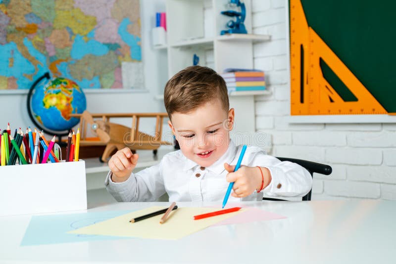 Elementary Boy Learning at Home. Cute Cheerful Child Drawing Stock ...