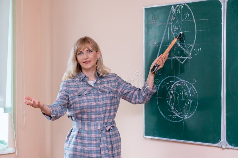 Back To School. the Professor Solves the Problem at the Blackboard ...