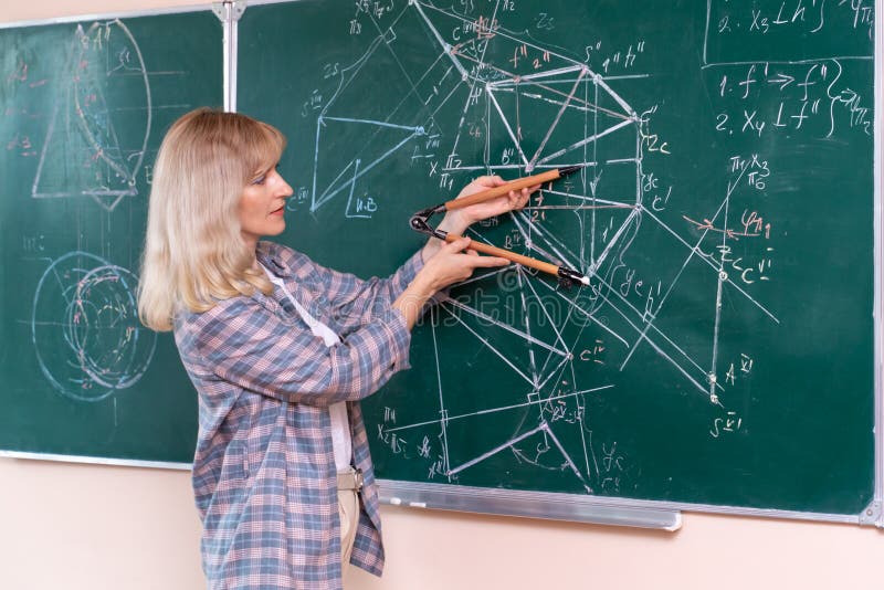 Back To School. the Professor Solves the Problem at the Blackboard ...