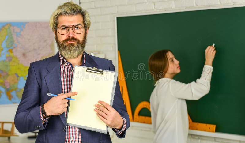 Back To School. Student and Teacher in Classroom. Teacher Checking ...