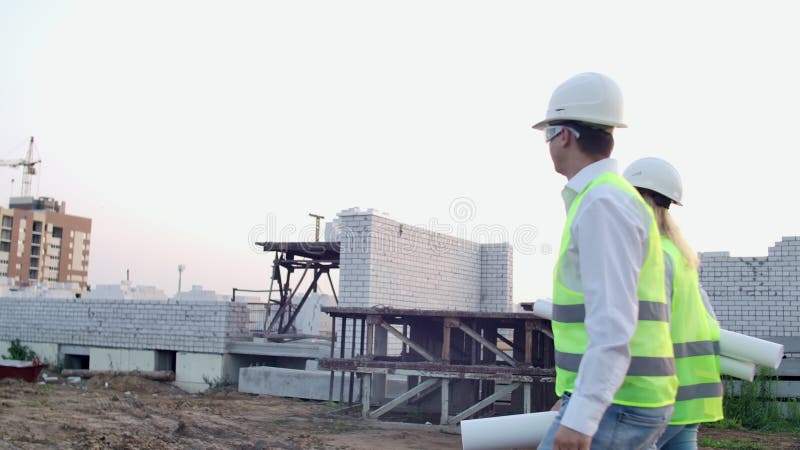 Back Turned Engineer and Technician at Construction Site Reviewing ...