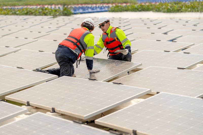 Back of Two Professional Technician Worker Sit in Area of Solar Cell ...
