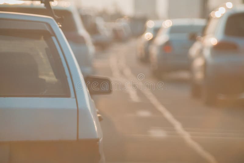 The Back of an Unknown Car at Sunset on Road in Heavy Traffic. Stock ...