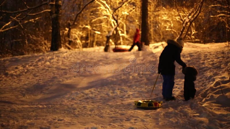 Back of Unrecognizable Woman and Kid with Snowtube Stock Footage ...