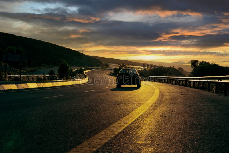 Back Vies of Car Driving on Winding Road at Sunrise Stock Photo - Image ...