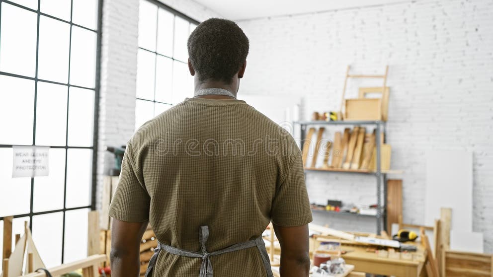 Back View of an Adult African Man Working in a Spacious Carpentry ...