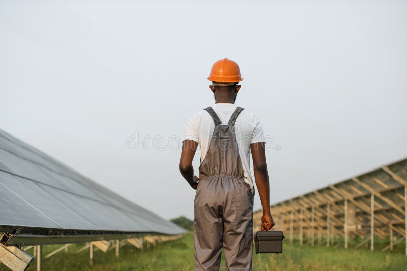 African American Man with Instruments Walking on Solar Farm Stock Image ...