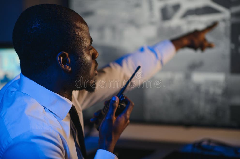 Back View of African American Security Operator Use Computer with ...