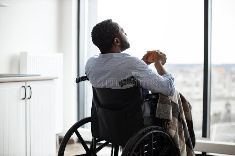 Back View of African American Wheelchair User with Cup of Hot Drink ...