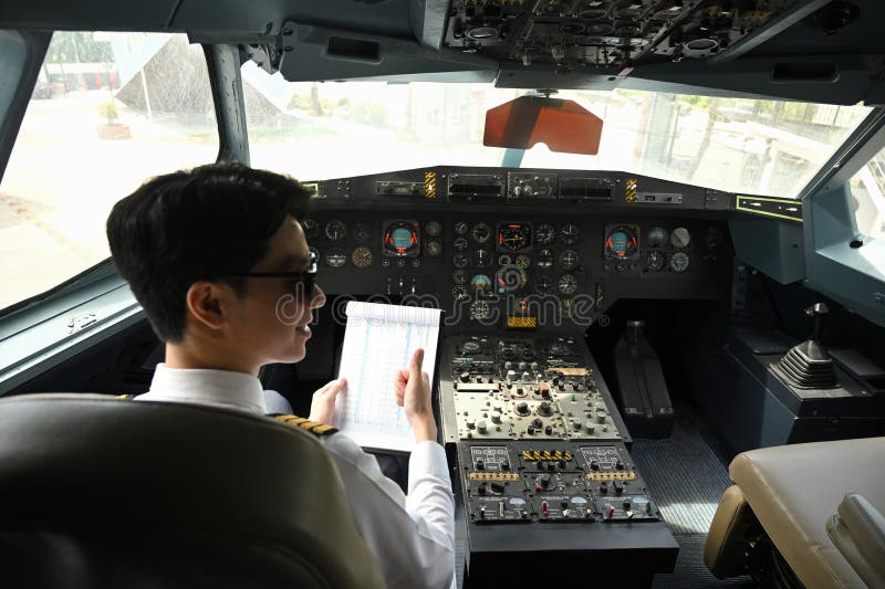Back View of Asian Pilot Dressed in a Uniform Preparing for Flight in ...