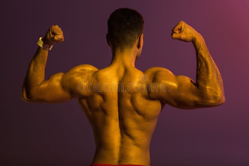 View of Athletic Man with Muscular Torso Demonstrating Biceps on Purple ...