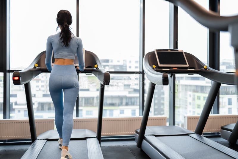 Back View of a Athletic Woman on a Treadmill. Stock Photo - Image of ...