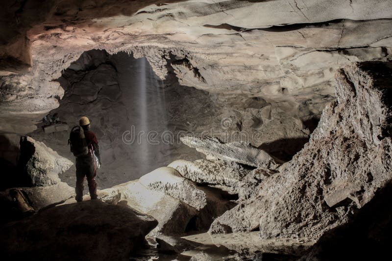 Back View of a Backpacker Hiking through a Cave Stock Photo - Image of ...