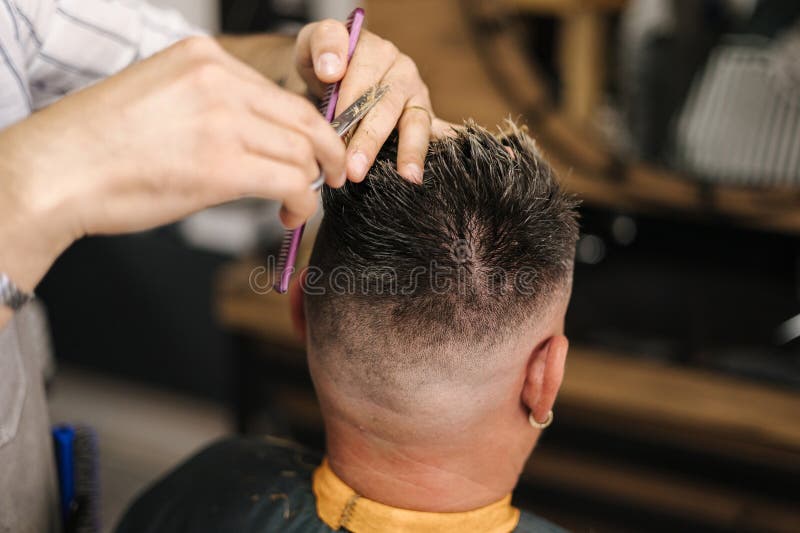 Back View of Barber Using Scissors and Making Hairstyle. Modern ...