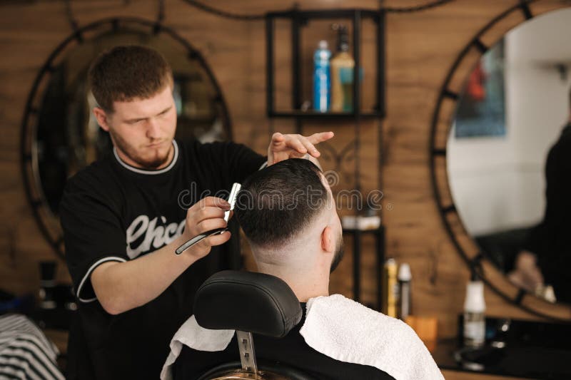 Back View of Barber Using Sharp Blade for Shaving. Handsome Customer ...