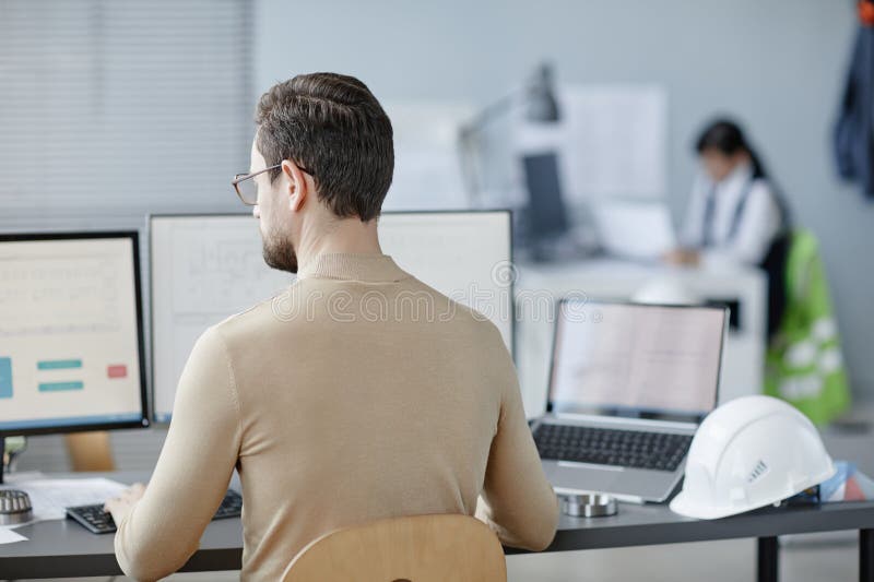 Back View of Bearded Engineer at Workplace with Hardhat on Table Stock ...