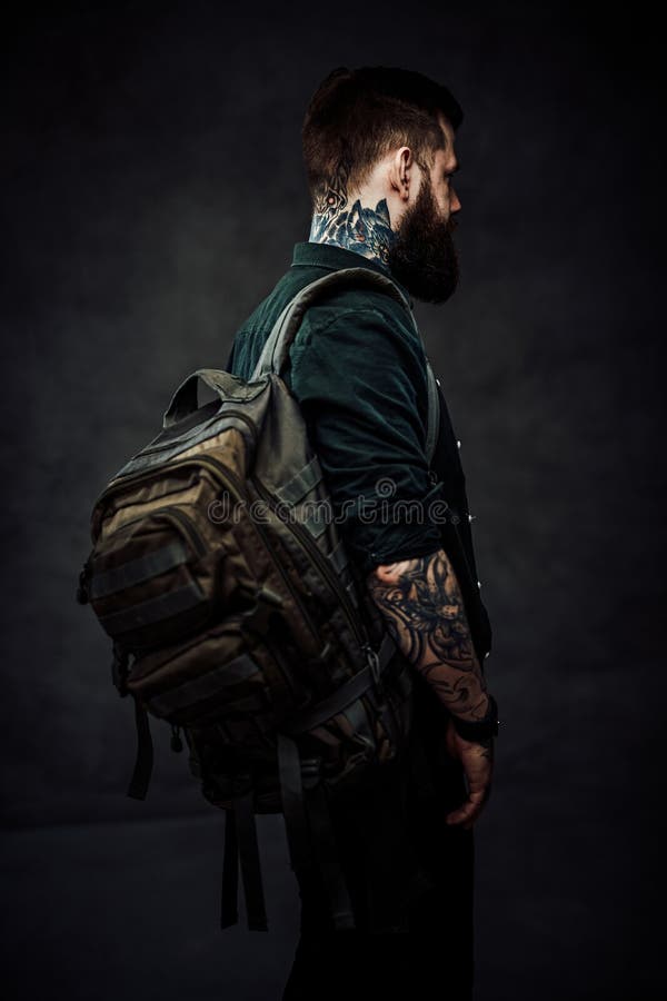 Back View of a Bearded Tattooed Hipster Guy with Backpack in a Dark ... Back View of a Bearded Tattooed Hipster Guy with Backpack in a Dark ...