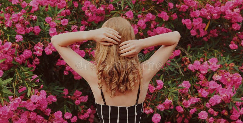 Back View Beautiful Happy Woman Raising Her Hands Up in Garden on Roses ... Back View Beautiful Happy Woman Raising Her Hands Up in Garden on Roses ...
