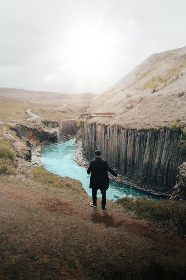 Back View of Black Man Standing on the Cliff Overlooking the River in ...