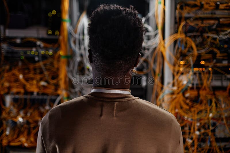 Back View Black Young Man As System Administrator Looking at Servers ...