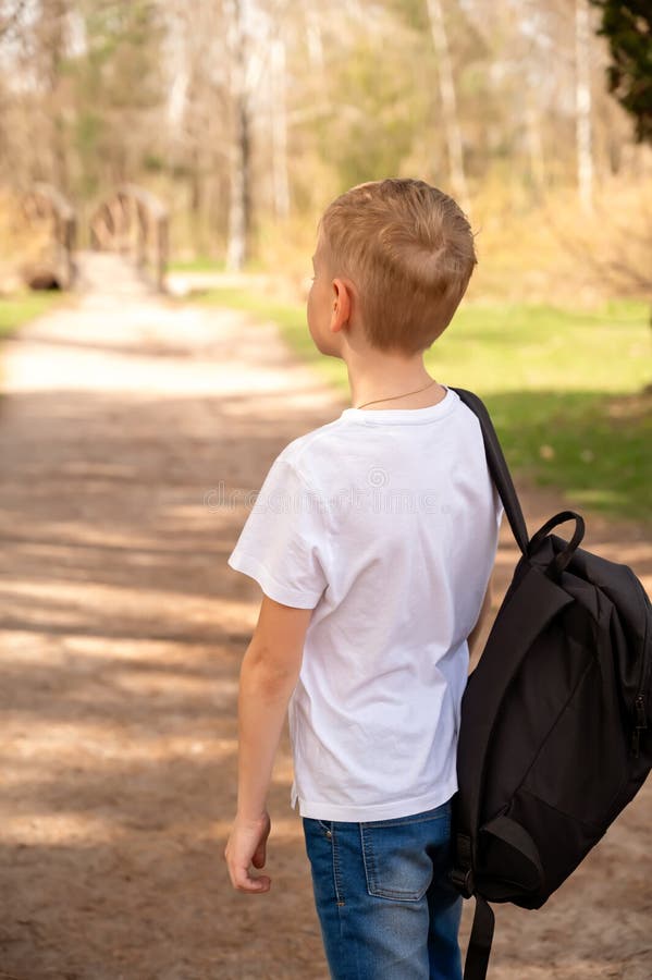 Back View of a Boy with Backpack Walking on a Path Stock Image - Image ...
