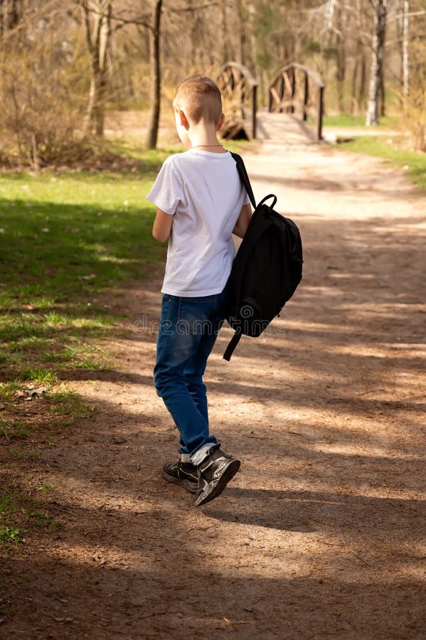 Back View of a Boy with Backpack Walking on a Path Stock Image - Image ...