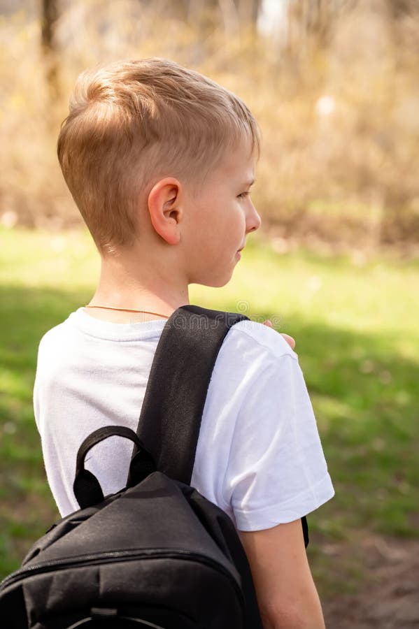 Back View of a Boy with Backpack Walking on Path in the Park Stock ...