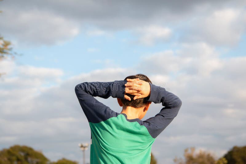 Back View of Boy with Hands on Head Looking Towards Stock Image - Image ...