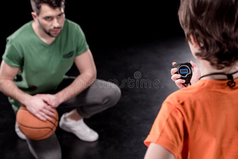 Back View of Boy with Stopwatch Controlling Time while Man Training ...