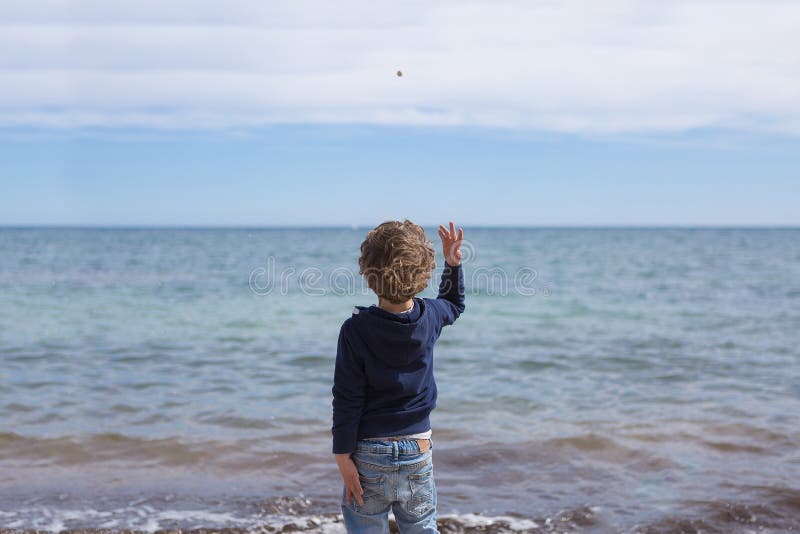 Back View of Boy Throwig Stone in Water Stock Photo - Image of outdoor ...