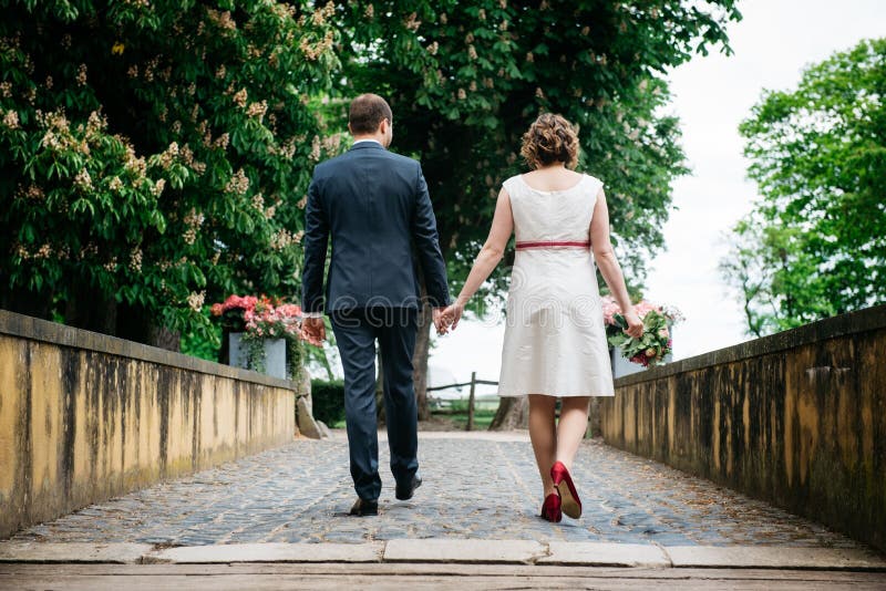 Back View of the Bride and the Groom Walking in a Park Stock Image ...