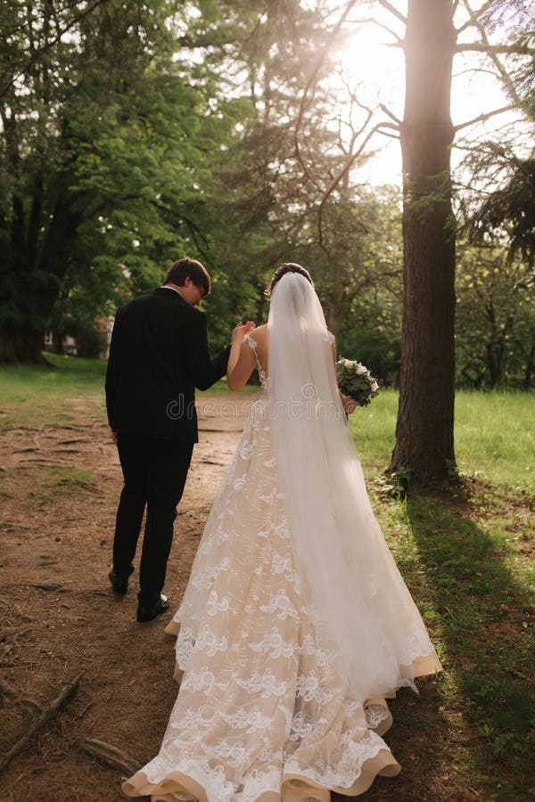 Back View of Broom and Bride Walking in the Forest Stock Photo - Image ...