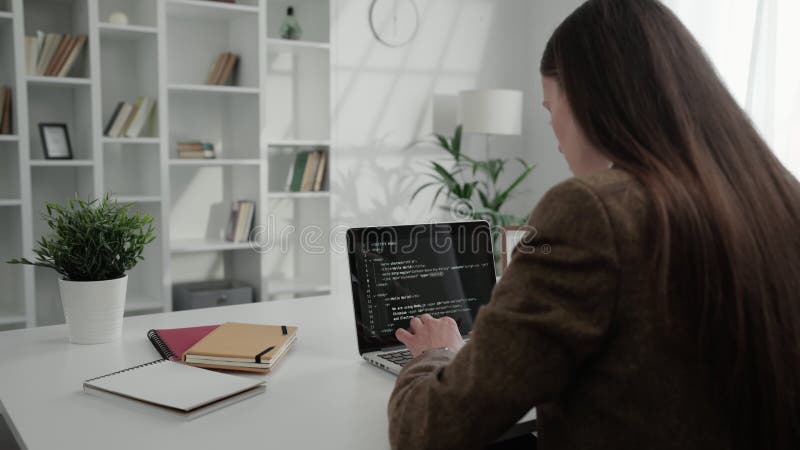 Back View of the Brunette Girl Sitting in the Home Office and ...