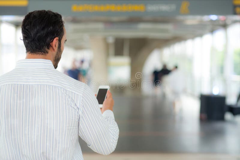 Back View of a of Businessman Using Mobile Smartphone. Stock Image ...