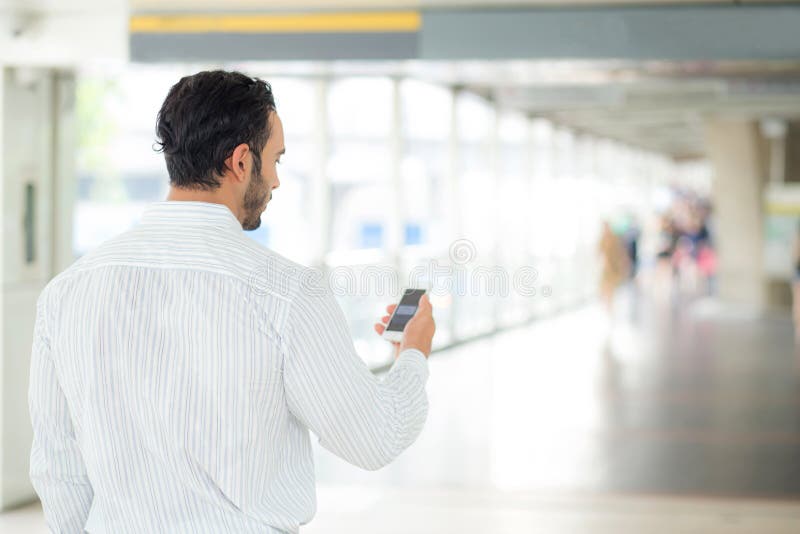 Back View of a of Businessman Using Mobile Smartphone. Stock Image ...