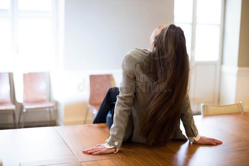 Back View of Young Businesswoman Sitting on Her Office Table Stock ...