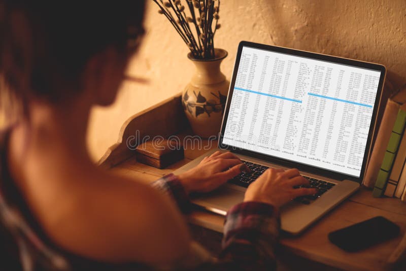 Back View Of Caucasian Female Programmer Siting At Desk Using Laptop With Coding On Screen