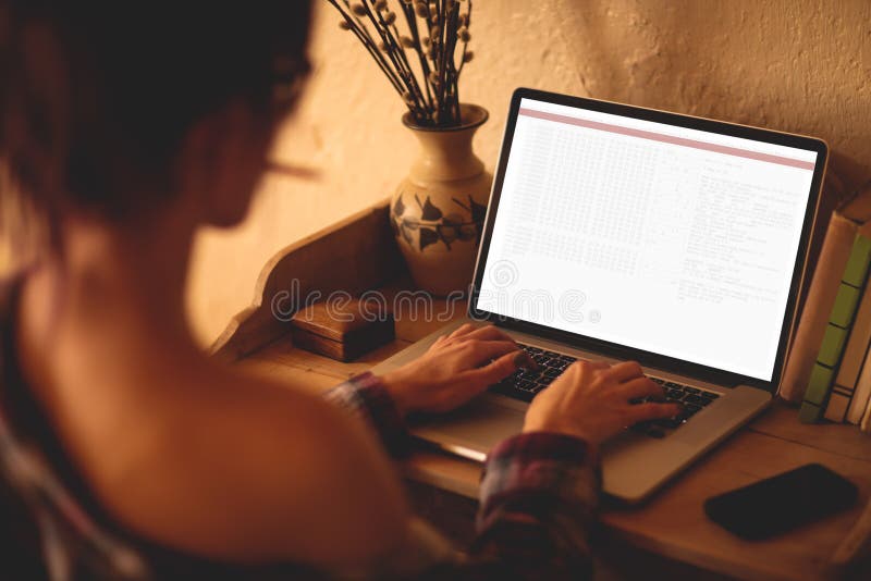 Back View of Caucasian Female Programmer Sitting at Desk, Using Laptop with Coding on Screen ...