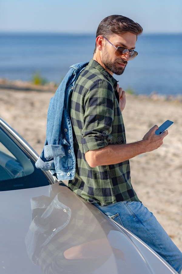 Back View of Caucasian Guy Texting on Phone while Standing at the Car ...