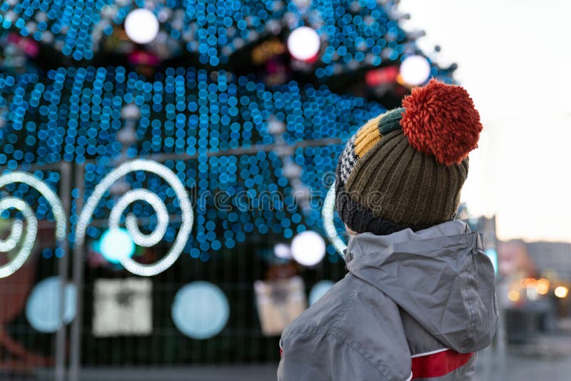Back View Child Looks at Christmas Tree and Christmas Decorations Stock ...
