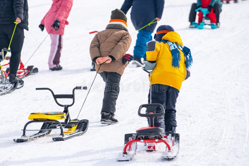 Back View of Child in Pulling Sledge and Running Up Snowy Slope Stock ...