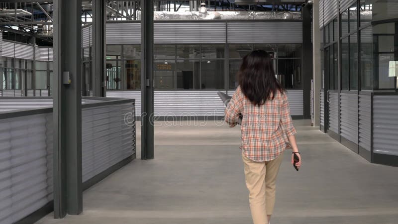 Back View of College Female Student Walking in Building Campus Corridor ... Back View of College Female Student Walking in Building Campus Corridor ...
