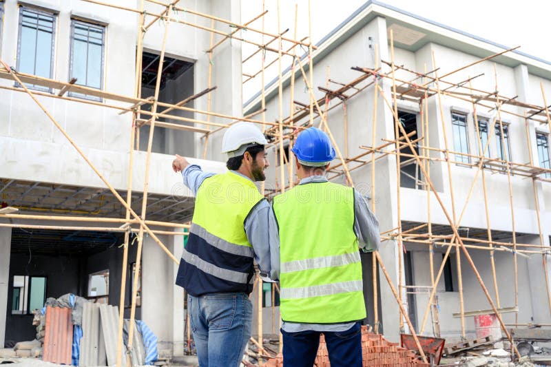 Construction Engineer and Architect with Blueprint Shaking Hands while ...