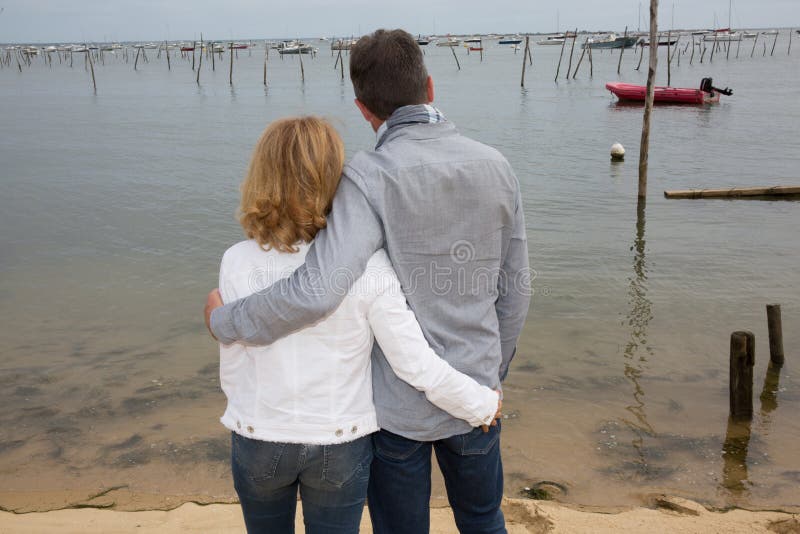 Back View of a Couple Hugging and Watching the Sea Stock Image - Image ...
